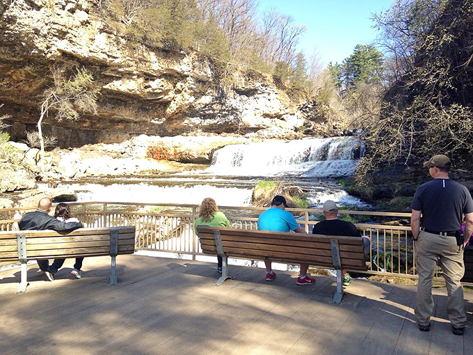 Spring brings vibrant greenery to the park's open meadows, creating peaceful contrast to the dramatic falls nearby.