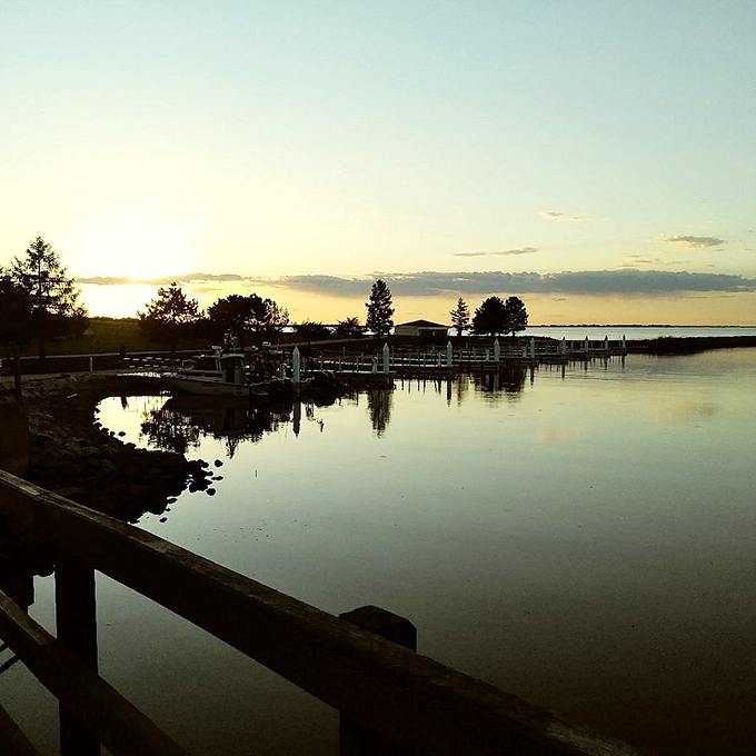 Stillwater at Dusk: The marina rests in perfect twilight reflection, boats nestled in their slips like tired children at day's end.