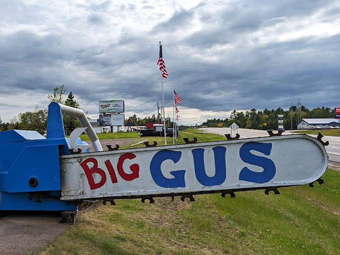 Big Gus, the world's largest chainsaw, rests on the lawn like a retired lumberjack's dream toy. Paul Bunyan would be jealous!