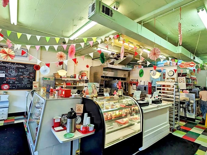 The cheerful interior is decorated with colorful bunting and vintage touches, creating a festive atmosphere for enjoying their award-winning treats.