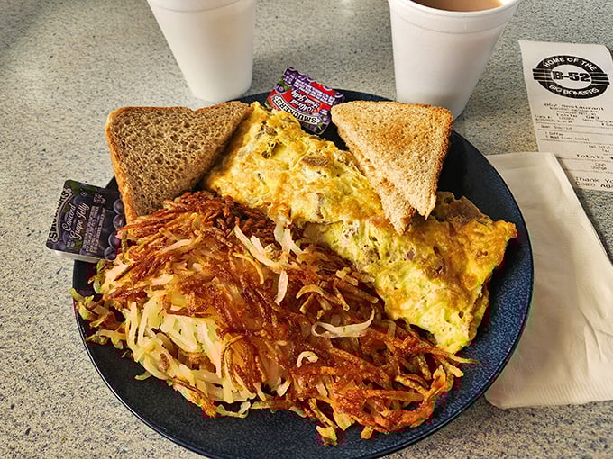 Breakfast perfection: a fluffy omelet with crispy hash browns and toast &ndash; the ideal fuel before your day takes flight.