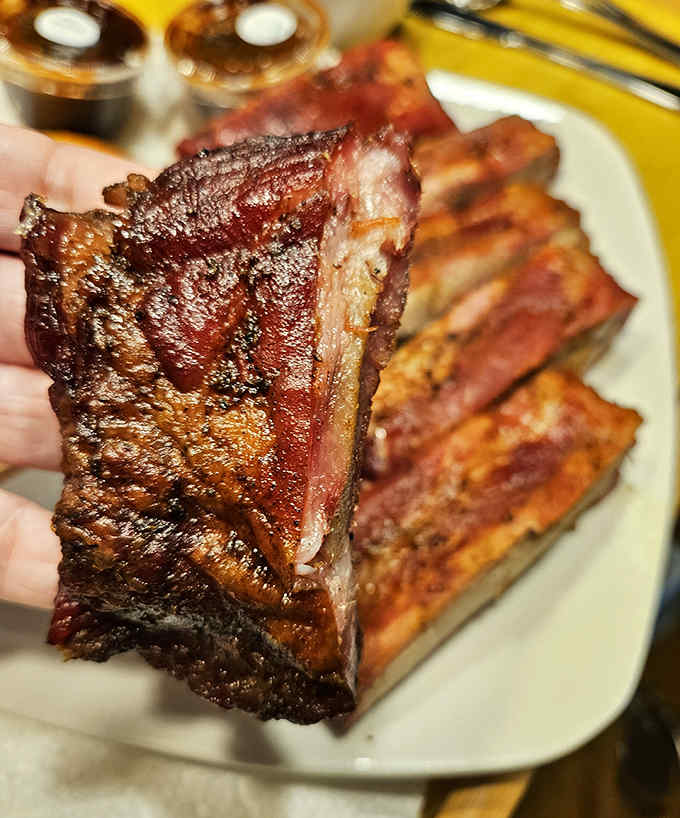 These ribs showcase the perfect pink smoke ring &ndash; nature's way of confirming you're about to experience meat nirvana.