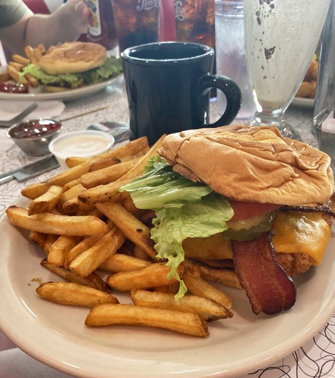 A burger so perfectly constructed it could teach architecture classes, with bacon that extends beyond the bun like meaty solar flares.