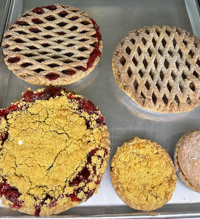 Lattice-topped cherry pies share space with crumble-crowned fruit creations, each one a testament to the timeless appeal of perfectly baked fruit encased in buttery pastry.