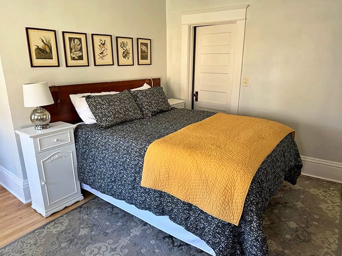 The bedroom's golden accents catch morning light like a crown catching sunbeams – waking up here feels positively regal.