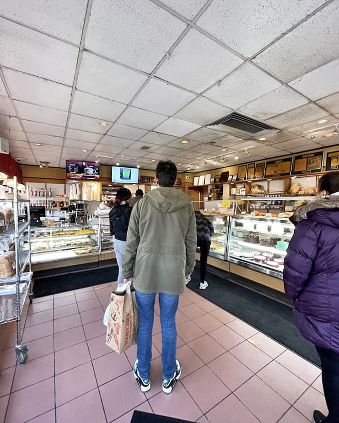Customers stand transfixed before glass cases of possibility, participating in the daily ritual of deliberation that precedes every Bennison's purchase.