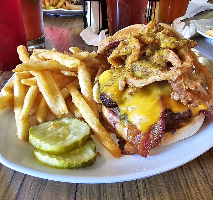 This isn't just a burger &ndash; it's an architectural masterpiece of beef, cheese, bacon, and toppings that requires both hands and a strategy.