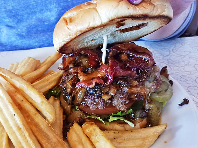 This Bourbon Burger stands as a monument to carnivorous delight – perfectly charred patty topped with caramelized onions and bacon cooked to magical crispness.