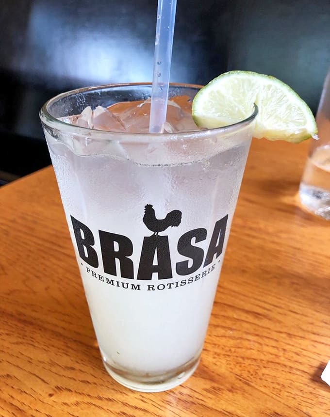 Refreshment with style &ndash; a house-made beverage in Brasa's signature glass, complete with a lime wedge for that perfect citrus kick.