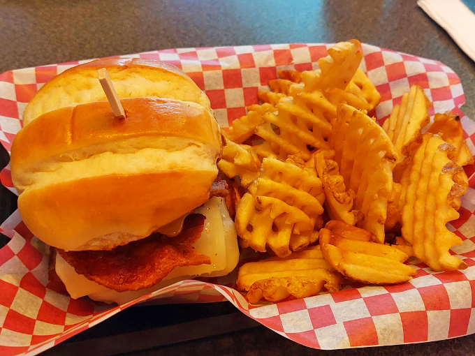 This burger with waffle fries isn't asking for your Instagram attention &ndash; it's demanding your undivided taste bud appreciation instead.