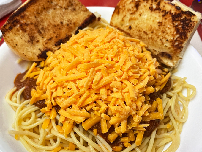 Cincinnati meets Italy in this hearty plate of chili-topped spaghetti. With that mountain of shredded cheddar, it's comfort food wearing a party hat.