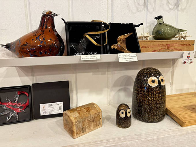 Glass birds perch with quiet elegance, showcasing the clean lines and natural inspiration that define Scandinavian decorative arts.