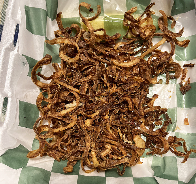 These crispy, beer-battered onion strings might just be the unsung heroes of the menu &ndash; order extra, you'll thank me later.