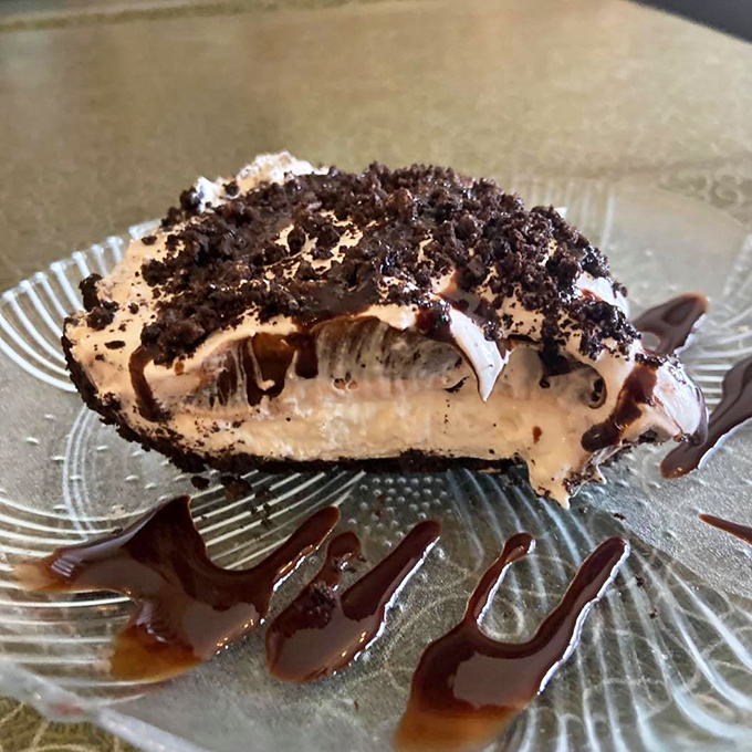 A decadent slice of chocolate cream pie with Oreo crumbles and chocolate drizzle that's worth saving room for, no matter how full you think you are.