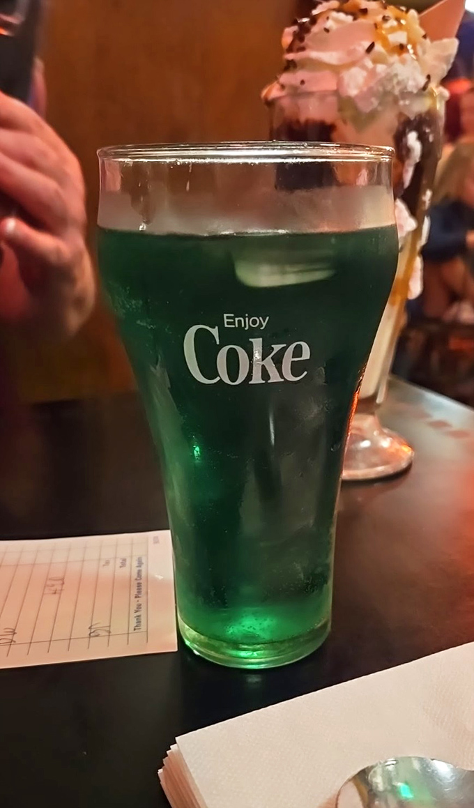 When bright green soda appears in vintage Coca-Cola glassware, you know you've found a place where nostalgia and flavor collide in the best possible way.