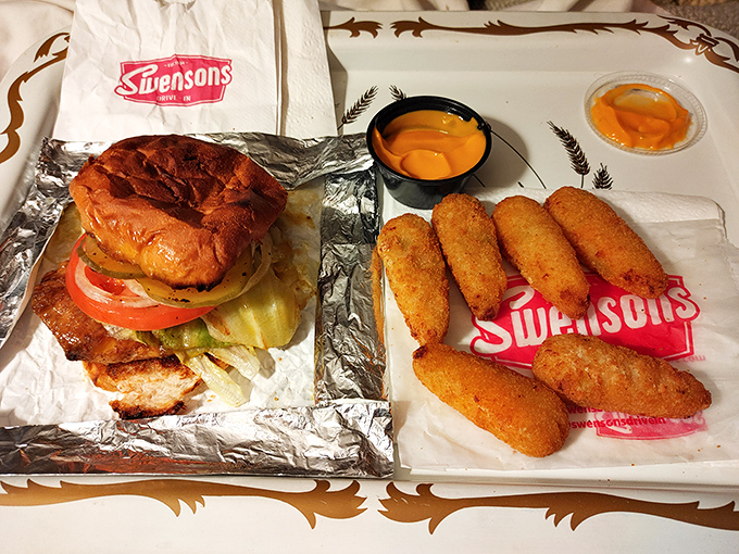 Drive-In Meal: The full Swensons experience &ndash; savory sandwich, golden potato offerings, and that signature foil wrapper that keeps everything piping hot.