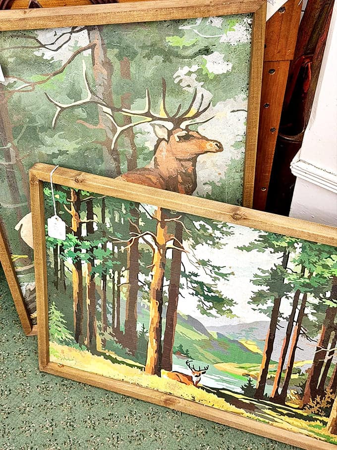 Majestic elk and serene forest scenes captured in vintage prints offer windows to the wild, perfect for that cabin aesthetic without the mosquitoes.
