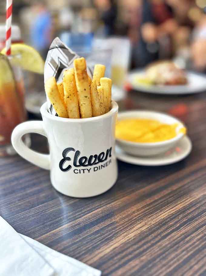 These aren't just fries &ndash; they're diner diplomats served in a signature mug, ready to be dipped in liquid gold cheese.