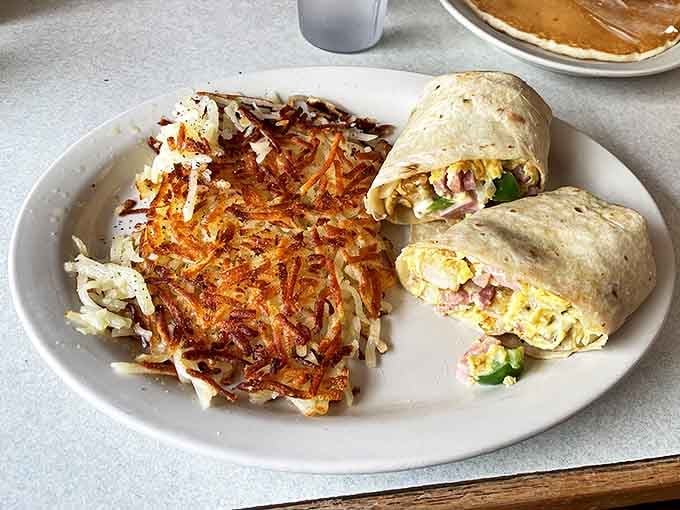 Crispy hash browns with the perfect golden crust alongside breakfast burritos stuffed with morning goodness &ndash; a dynamic duo.