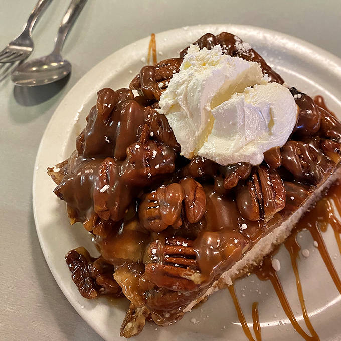 Caramelized pecan pie that's basically dessert masquerading as breakfast. That scoop of vanilla ice cream melting into warm caramel sauce is pure morning decadence.