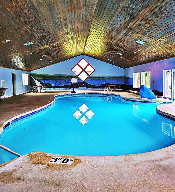 The indoor pool area features rustic wooden beams and panoramic murals &ndash; swimming with all the scenery, none of the mosquitoes.