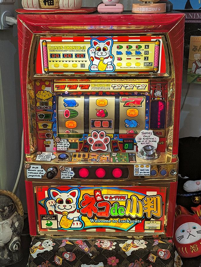 This vintage Japanese Pachinko machine features lucky cats, combining gambling entertainment with the eternal hope for good fortune.