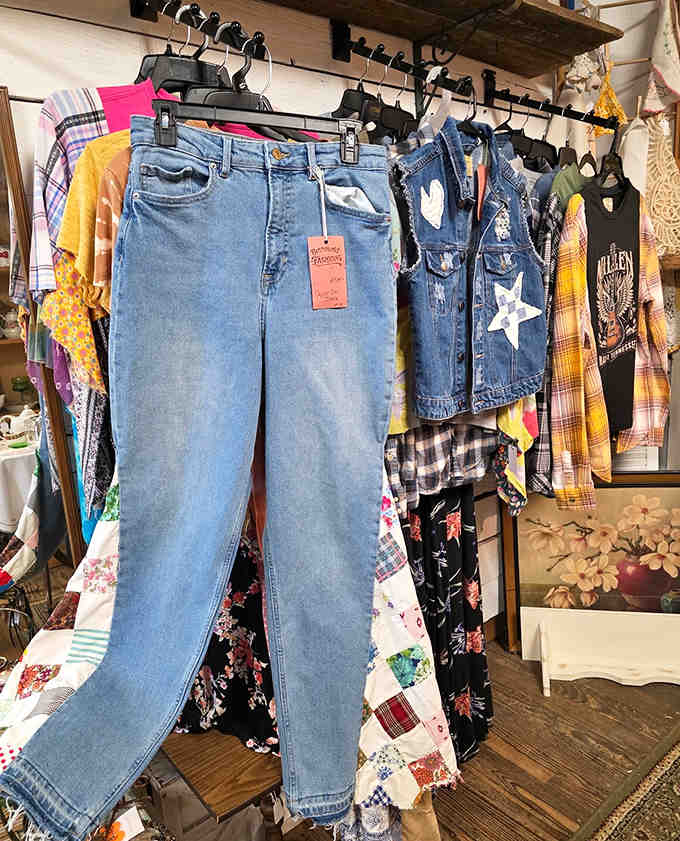 Vintage denim and patchwork clothing hanging like fabric time machines, ready to transport wearers back to eras when fashion had personality.