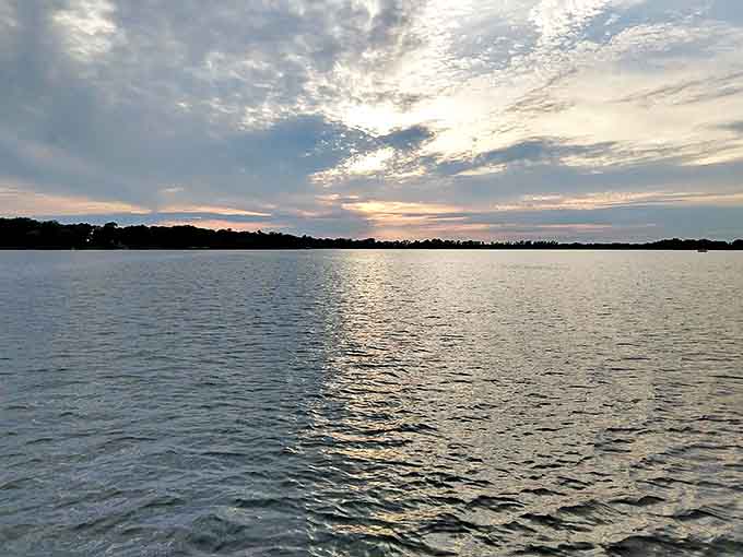 Lake Ripley's glassy surface reflects clouds and dreams alike, offering a moment of Minnesota tranquility that no spa treatment could ever match.