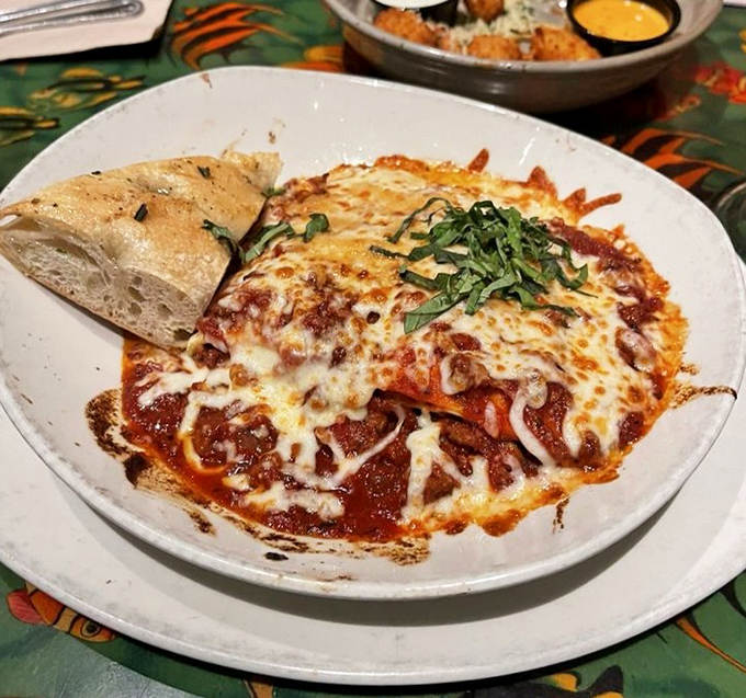 Lasagna that bubbles like a volcanic hot spring, its cheese layer stretching skyward with each forkful like nature's most delicious rubber band.