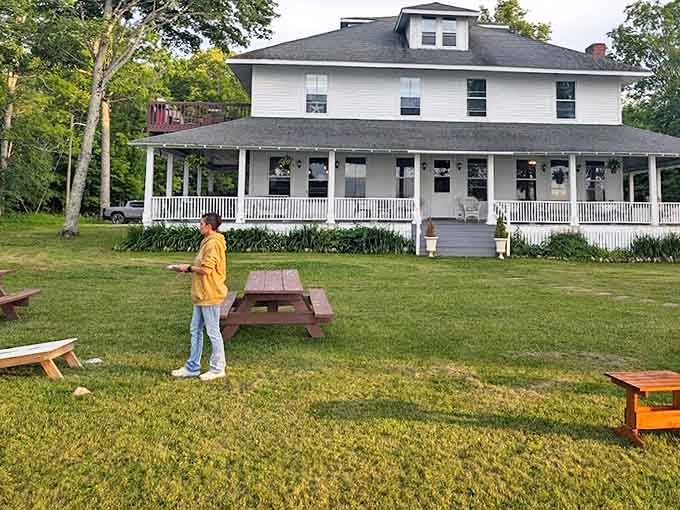 The sprawling lawn invites impromptu games, lazy afternoon naps, or simply standing still to appreciate the perfect Michigan moment.