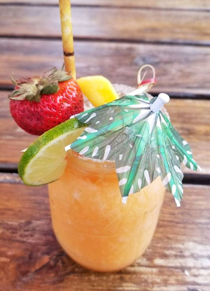 A tropical vacation in a glass &ndash; the mango margarita brings sunshine to the northwoods with its festive umbrella and fresh fruit garnish.