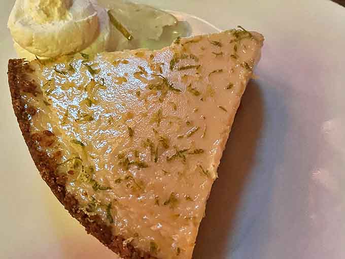 The Key Lime Pie delivers the perfect balance of tart and sweet, its pale yellow filling and coconut-infused crust offering a refreshing finale.