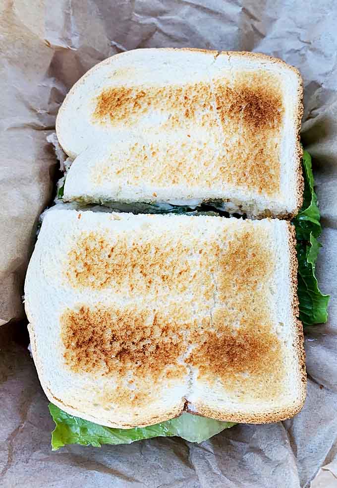 This club sandwich stacked with turkey, bacon, and crisp vegetables shows that lunch here is just as serious as breakfast.