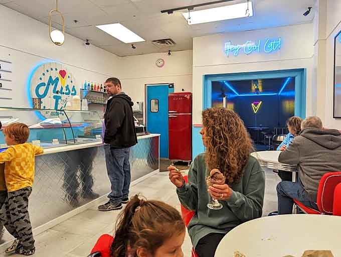 Where families create sweet memories one scoop at a time, under the watchful glow of "Hey Cool Cat!" neon.