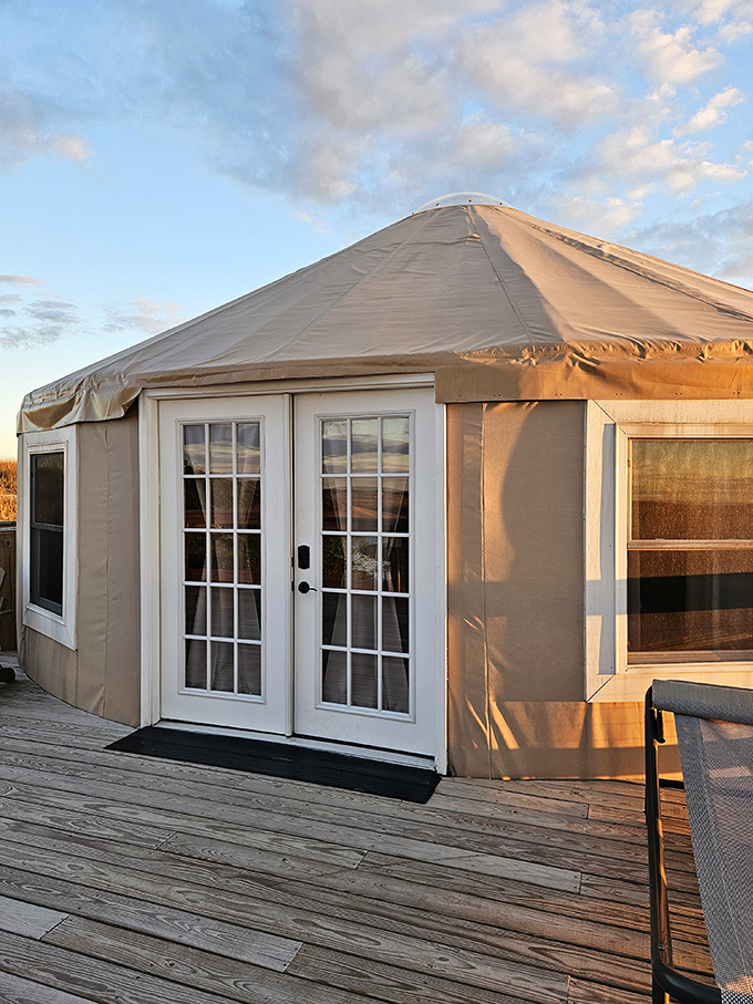 The modern yurt exterior blends seamlessly with nature while promising the comforts that make "roughing it" feel anything but rough.