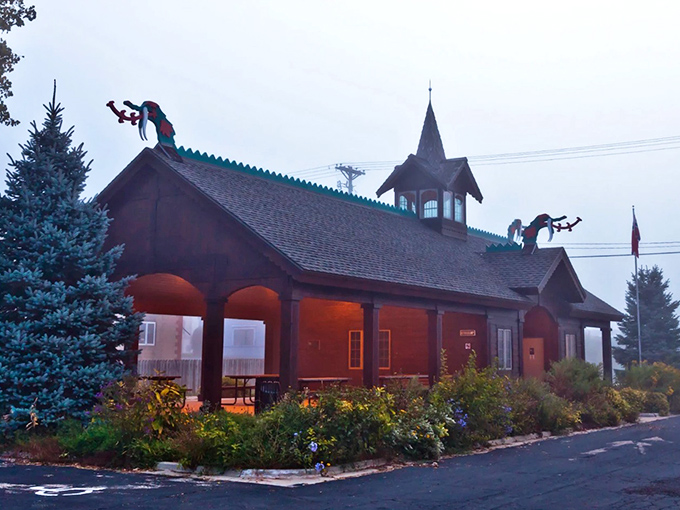 Mount Horeb's Chamber of Commerce building blends traditional architecture with playful rooftop figures, because even official business needs a dash of whimsy.