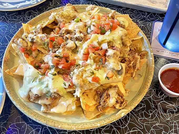 A mountain of tortilla chips buried under cheese, meat, and toppings &ndash; appetizer or main course? Yes.