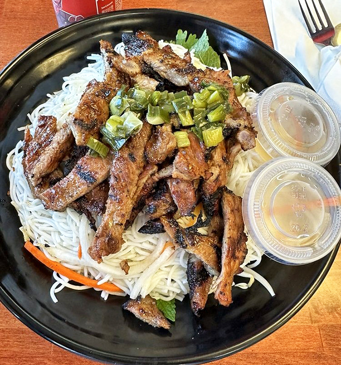 Vermicelli noodles cradle perfectly grilled pork in this bowl of happiness, where every bite delivers a perfect balance of savory, sweet and fresh.