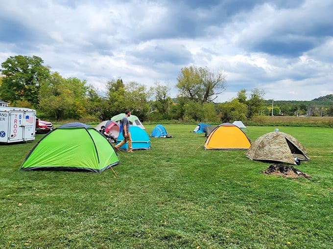 Colorful tents dot the landscape like confetti, each one housing dreamers who chose stars over ceilings for the night.