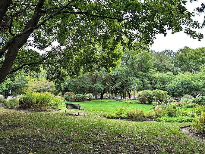 Emerald lawns stretch invitingly across the park, creating open spaces where community life unfolds against a backdrop of literary fantasy.