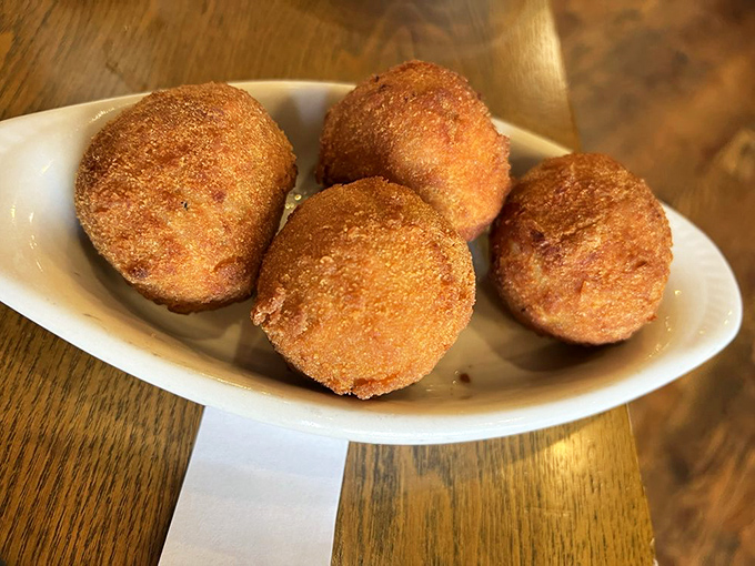 Golden-fried potato bombs hiding seasoned beef centers &ndash; crispy outside, fluffy inside, and utterly irresistible all around.