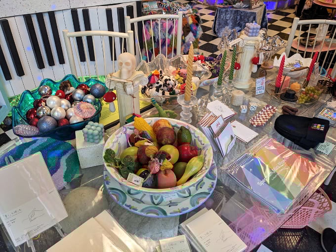 A feast of stationery, art supplies, and quirky decor items arranged with the careful precision of someone who color-codes their record collection.