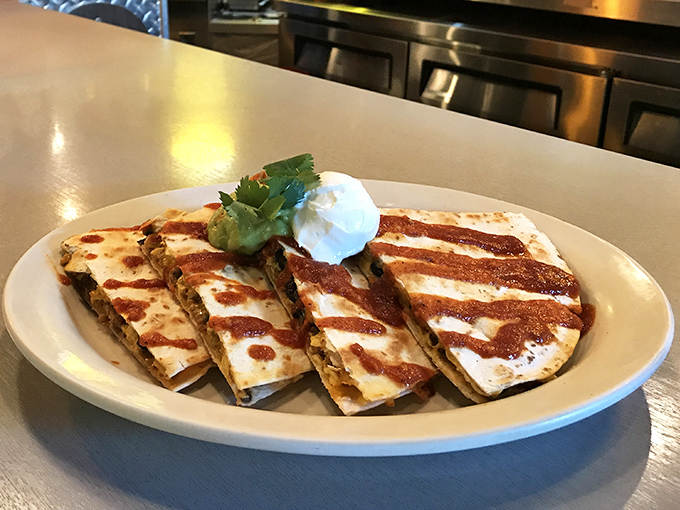 Quesadillas with a breakfast twist &ndash; crispy tortillas filled with morning favorites and striped with sauce, proving good ideas know no mealtime boundaries.