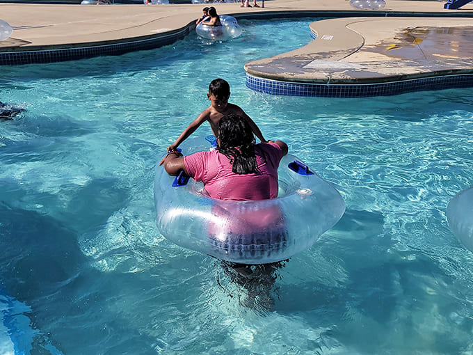 Kids living their best lives in inner tubes, spinning in circles and laughing like it's the greatest day ever.
