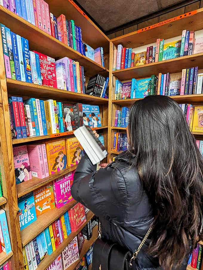 A reader browses romance titles, where happy endings are guaranteed and the only question is how the characters will get there.