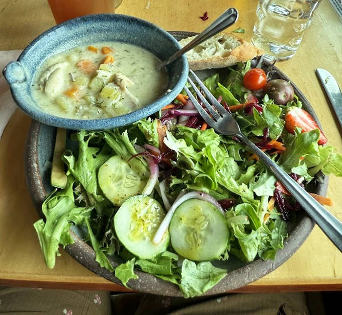 A vibrant house salad paired with creamy fish chowder offers the perfect balance of freshness and comfort in one satisfying meal.