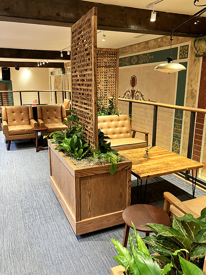 Comfortable seating areas with mid-century modern chairs invite visitors to linger with their literary finds.