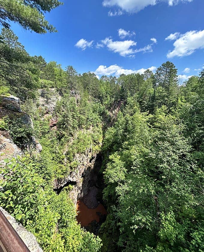 Forest meets sky: The lush Minnesota landscape creates a striking contrast with the mine's industrial remnants, nature and history in perfect balance.