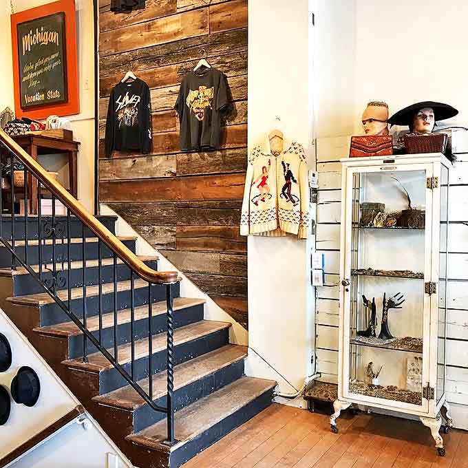 Navy blue steps lead to upper-level treasures, with reclaimed barn wood creating the perfect backdrop for decades of fashion history.
