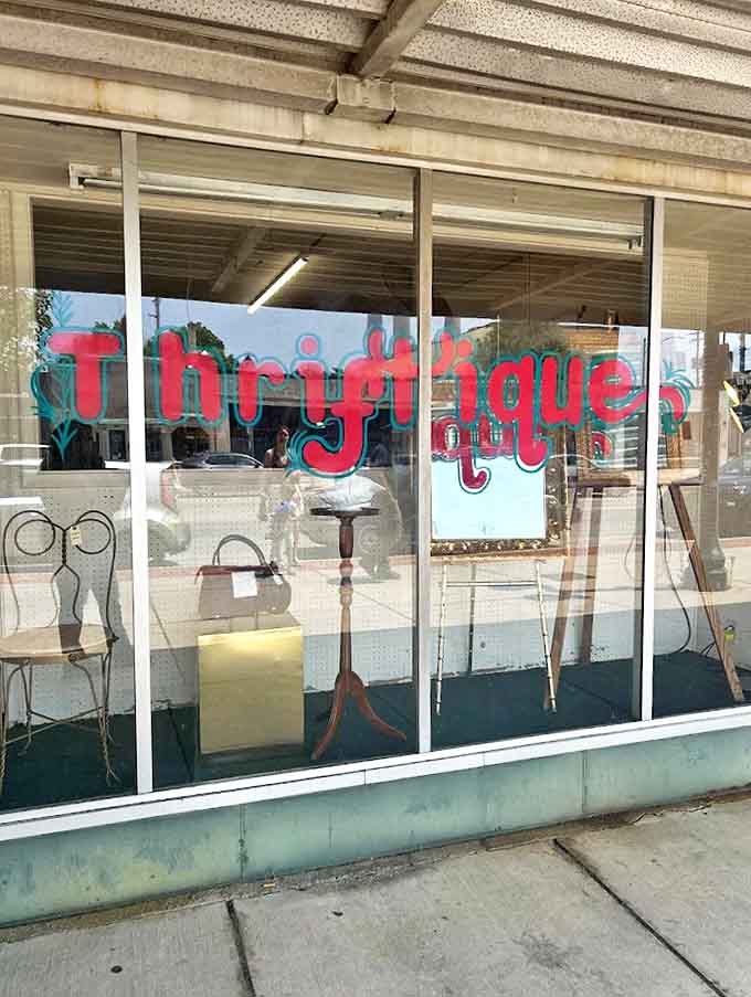 The display window offers tantalizing glimpses of vintage furniture treasures, each piece carefully arranged to catch the eye of passersby with an appreciation for timeless design.